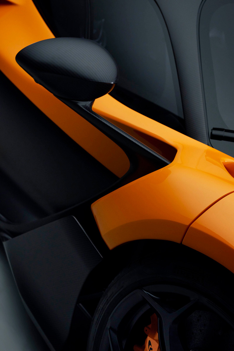 A close-up side profile of the McLaren W1, showing its two-tone orange ...