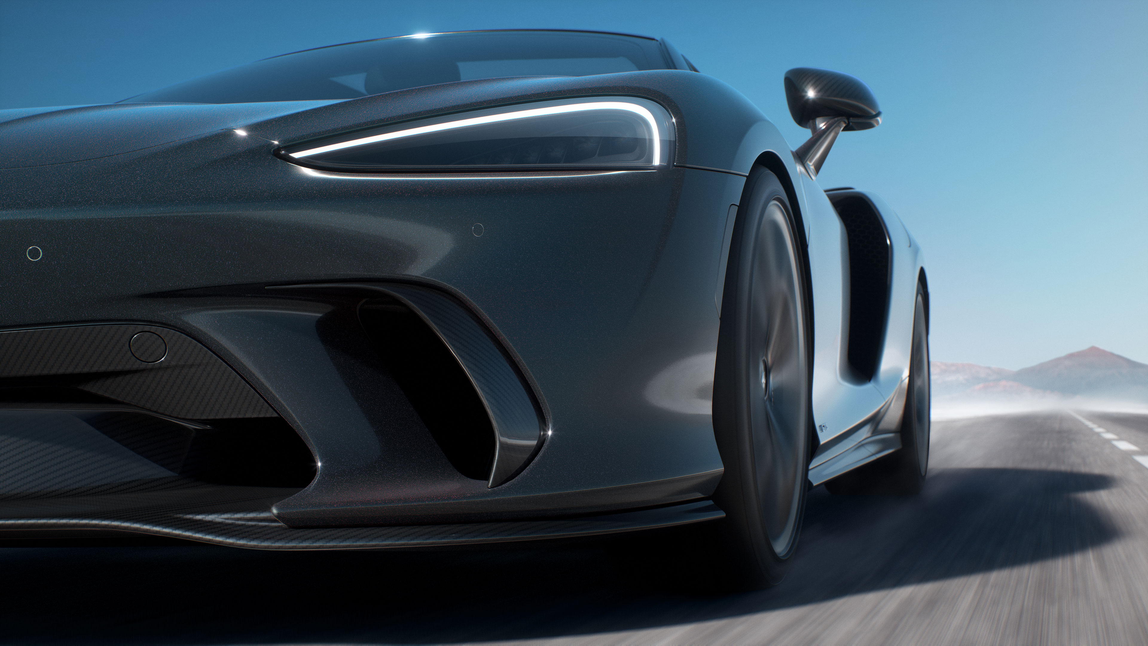 A low-angle view of the McLaren GTS's front end, highlighting its sleek ...